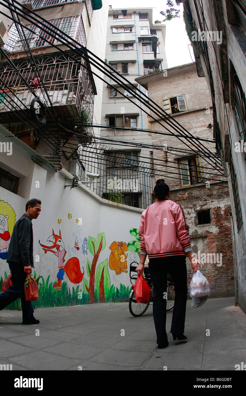 Chinese commuters making their way through the urban residential areas ...