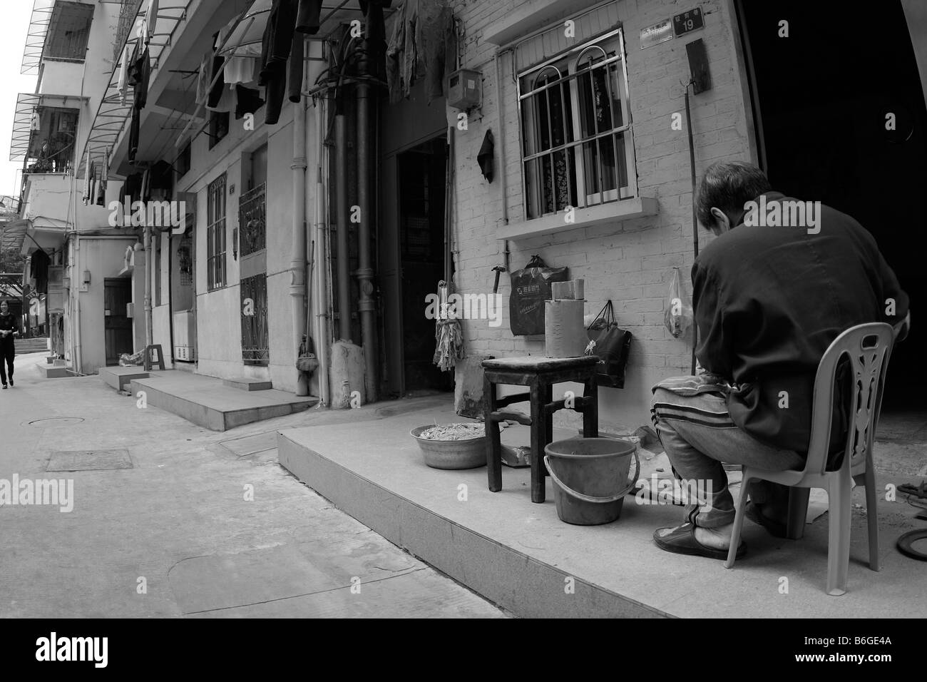 Street scene Local Cantonese Chinese residents sitting in front of ...