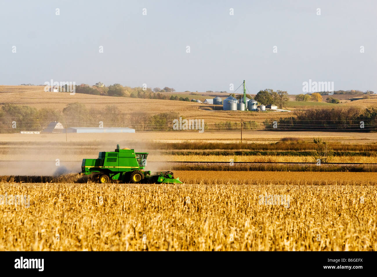 A John Deere combine harvests a field of soy beans in western Iowa ...