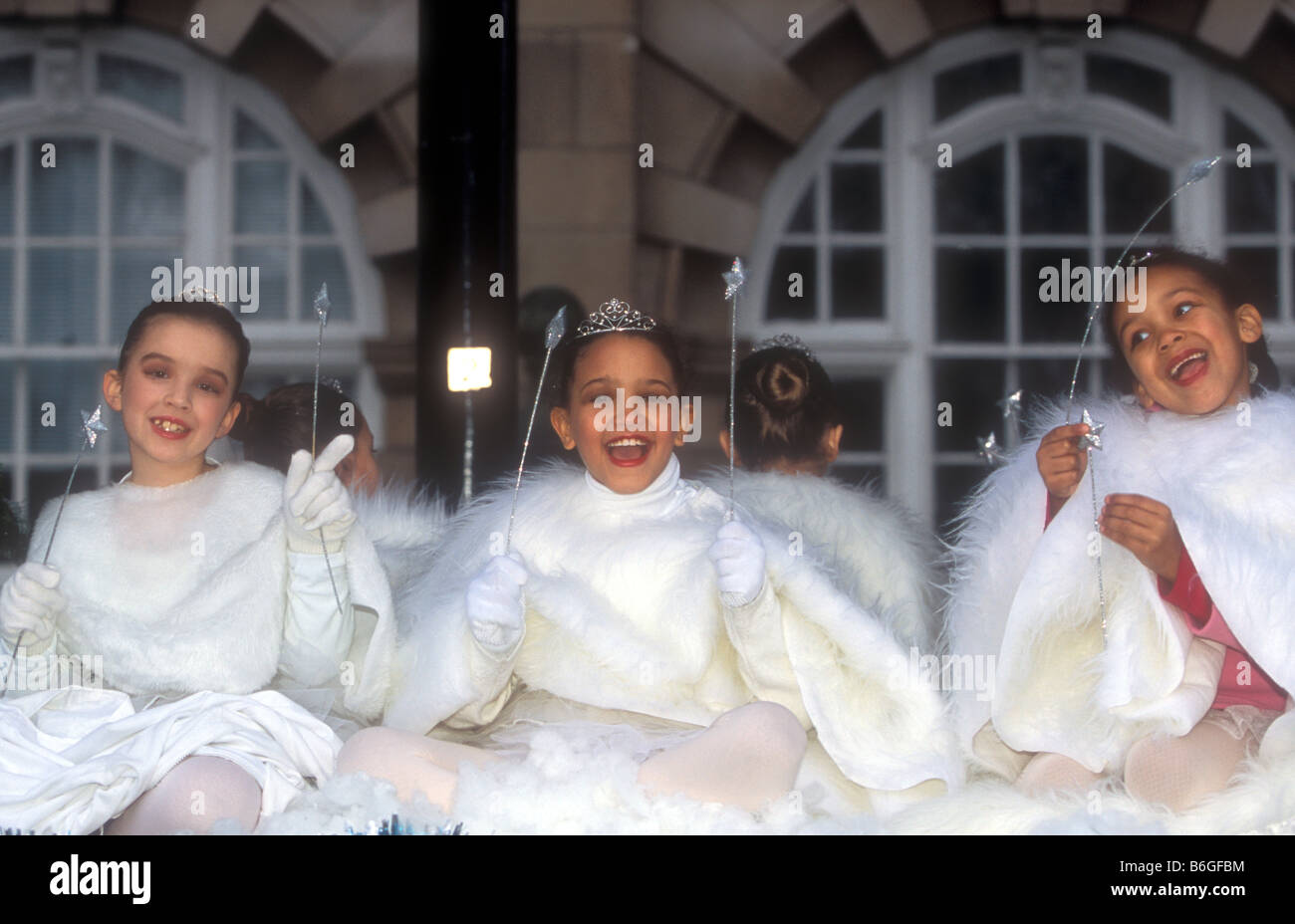 Young girls dressed as a fairies laughing on a float for the new years ...