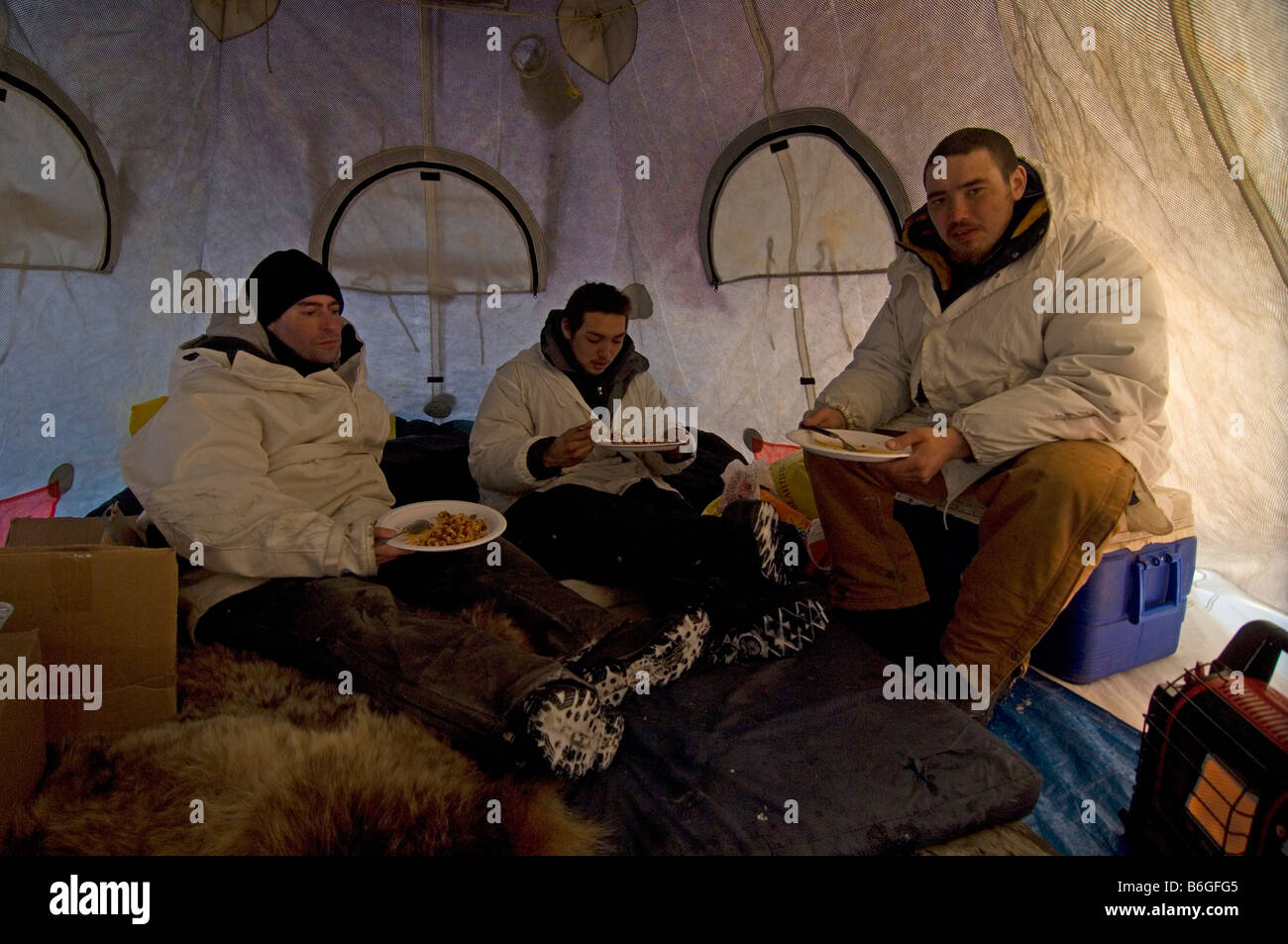 inupiaq whalers rest and eat in a wall tent on the pack ice during ...