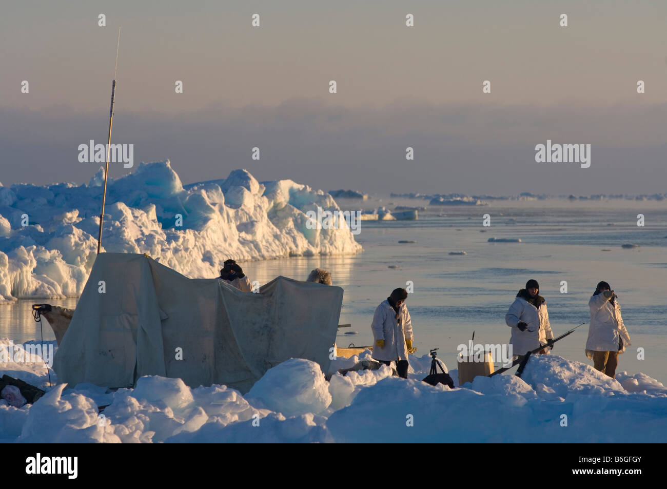 Inupiaq whalers with an umiak and wind blind wait for passing bowhead ...