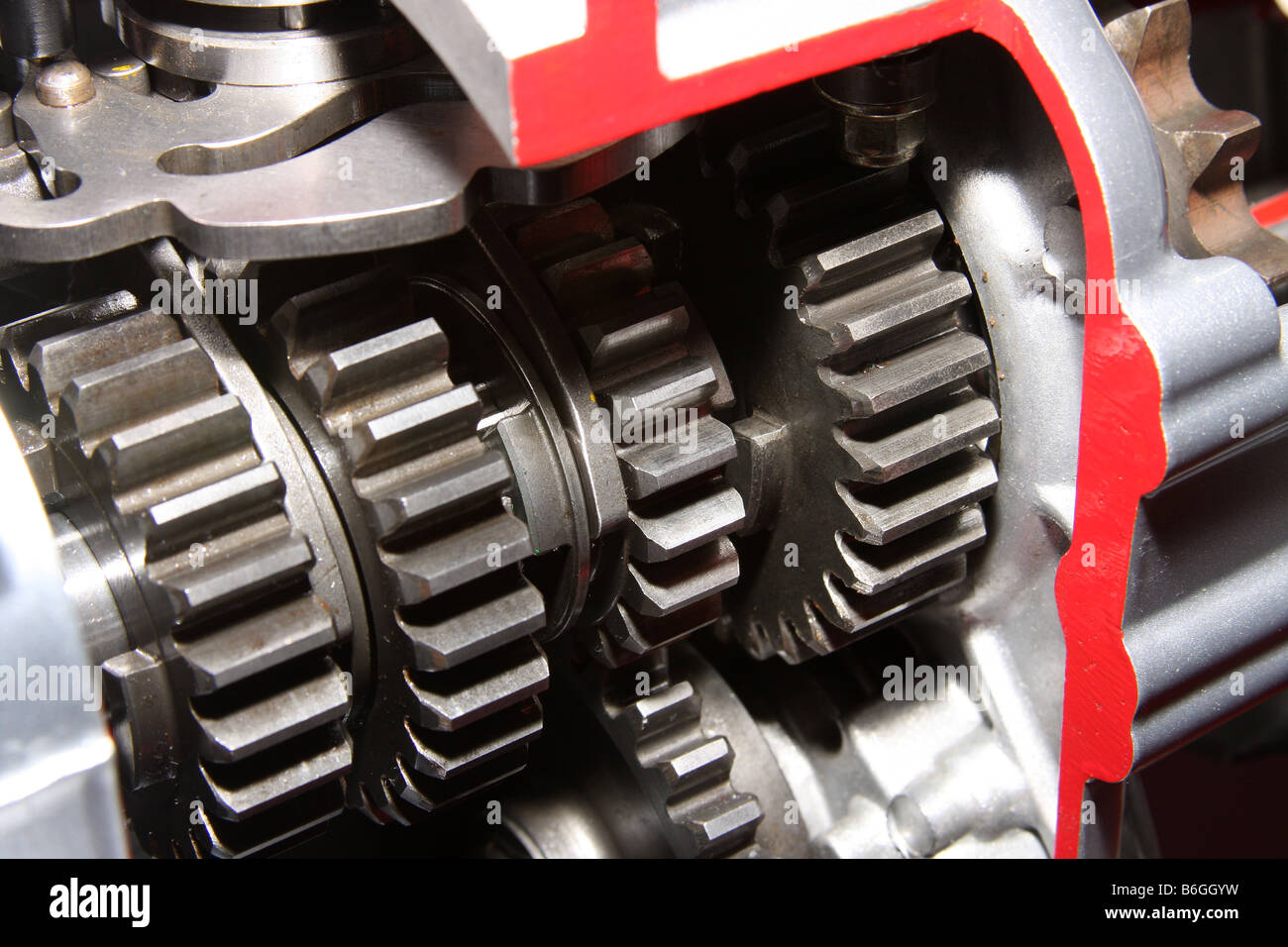 Close up of gear wheels in cut away section of modern motor cycle ...