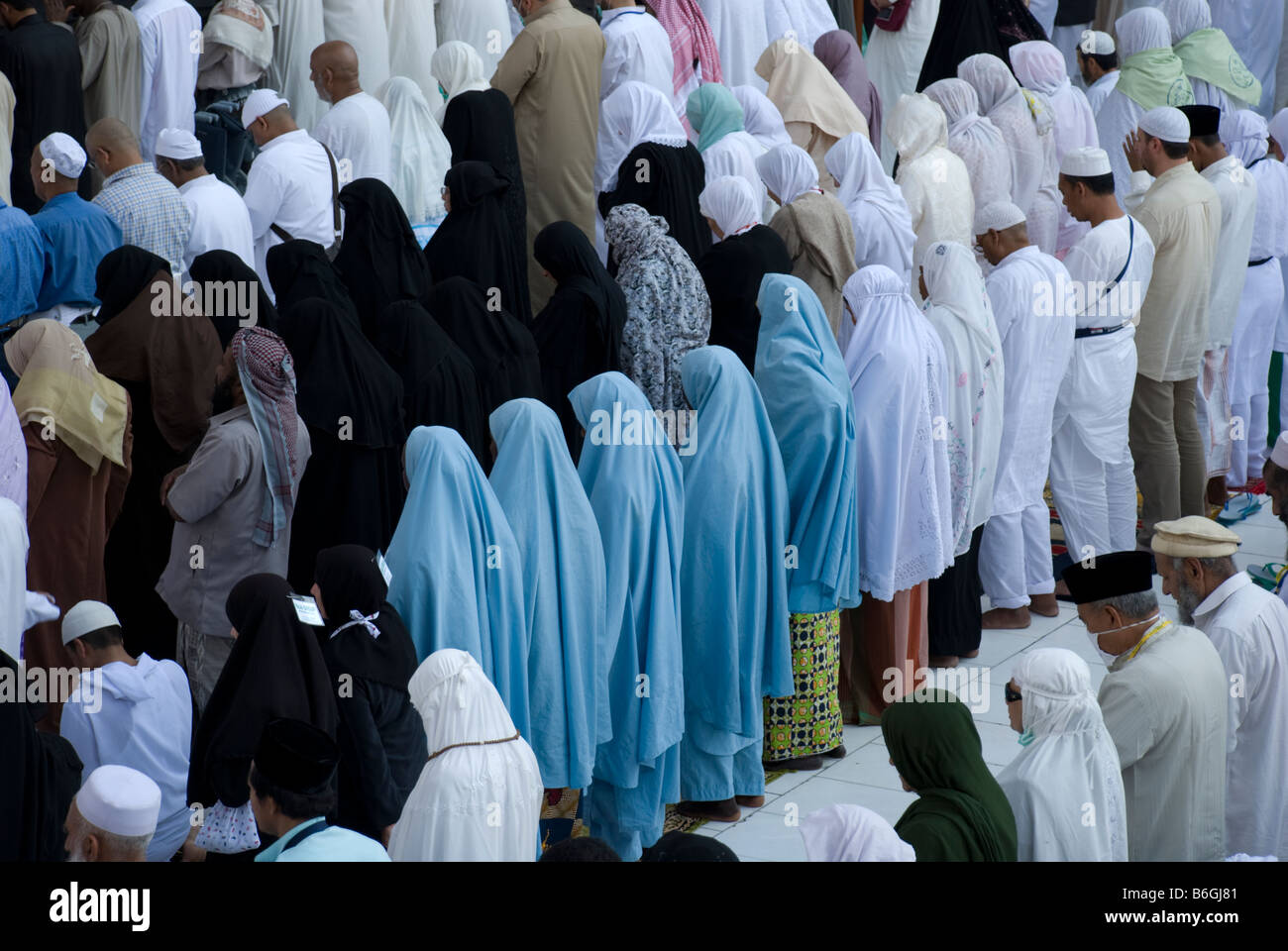 Male and female pilgrims praying the afternoon prayer asr together in ...