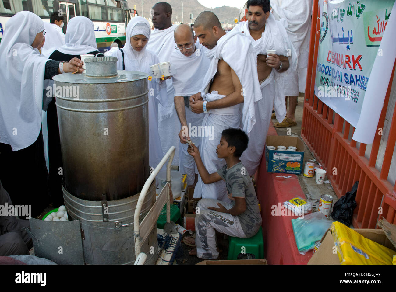Muslim pilgrims buying tea from a street seller in the european part of ...