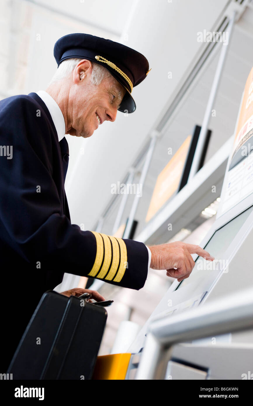 Flight captain using boarding computer Stock Photo - Alamy