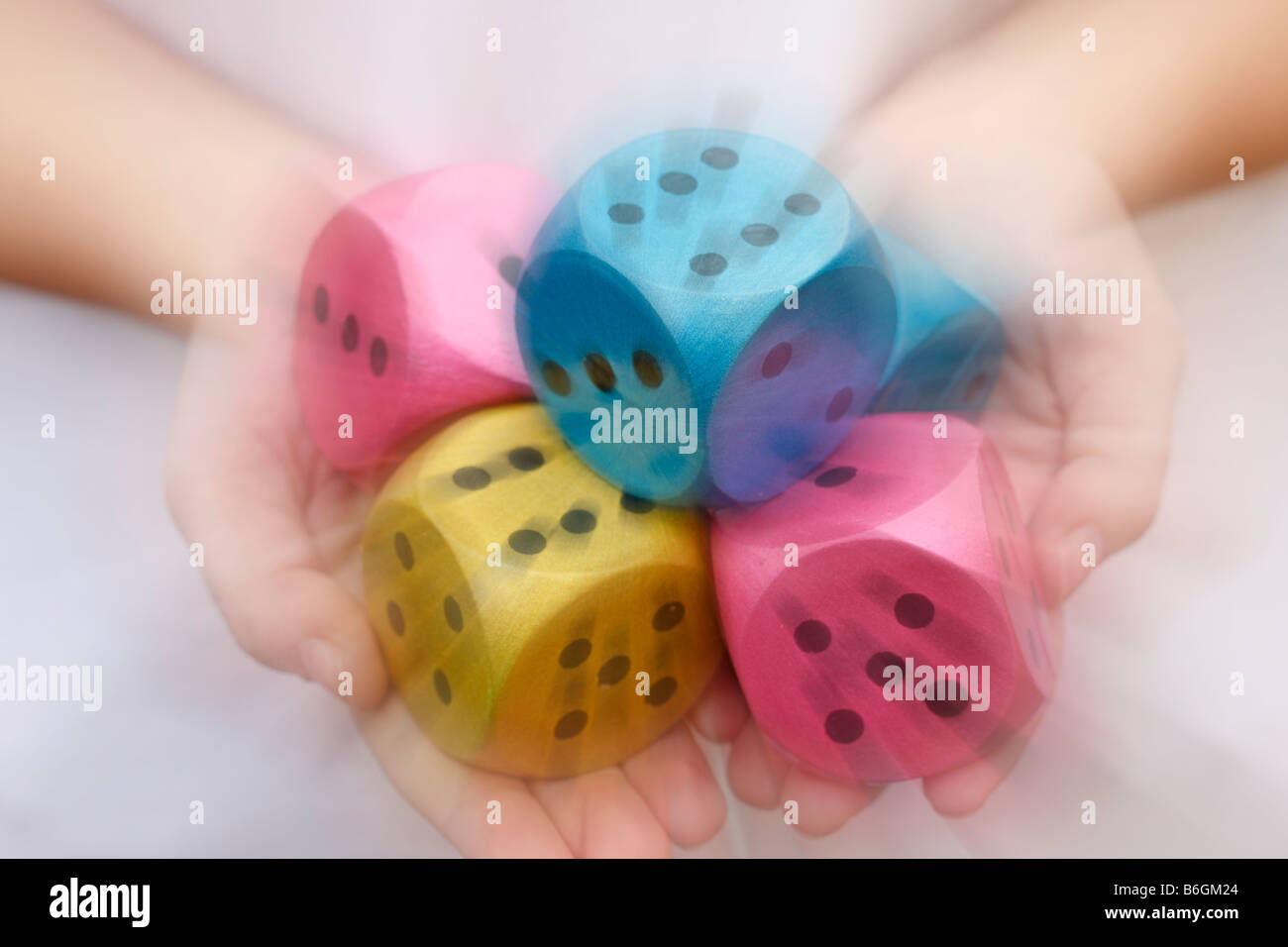 Dice on hands Stock Photo - Alamy