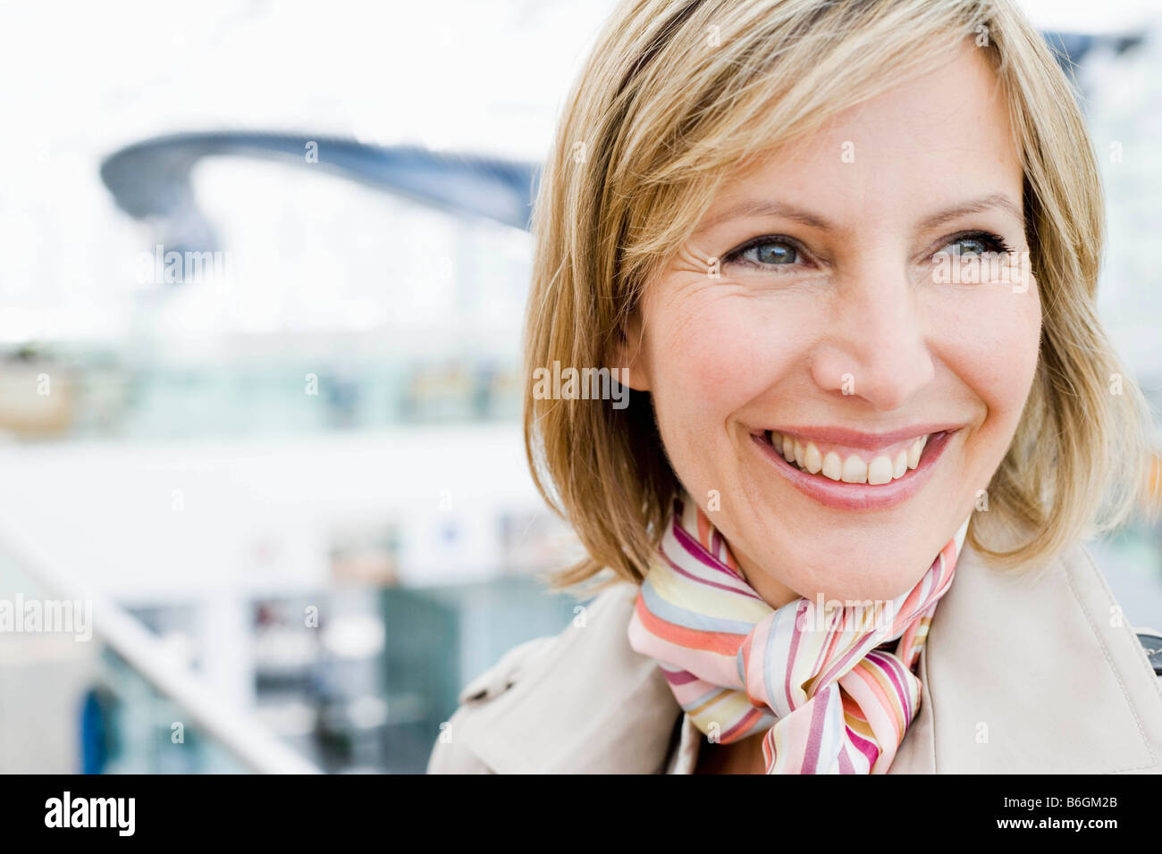 Woman close up smiling into distance Stock Photo - Alamy