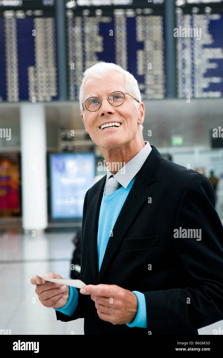 Older man holding ticket Stock Photo - Alamy
