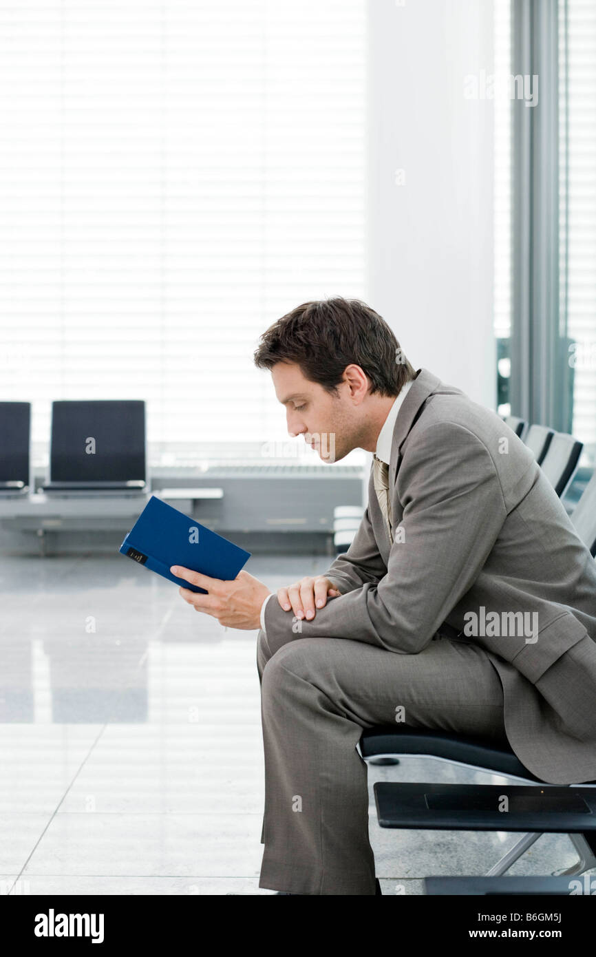 Man sitting reading book Stock Photo - Alamy