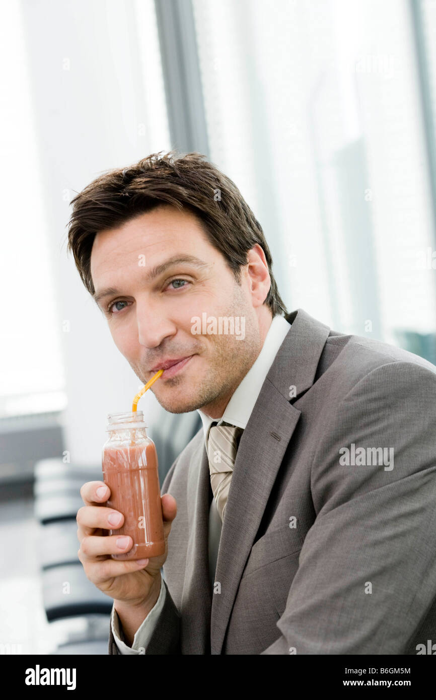 Man drinking with straw from a bottle Stock Photo - Alamy