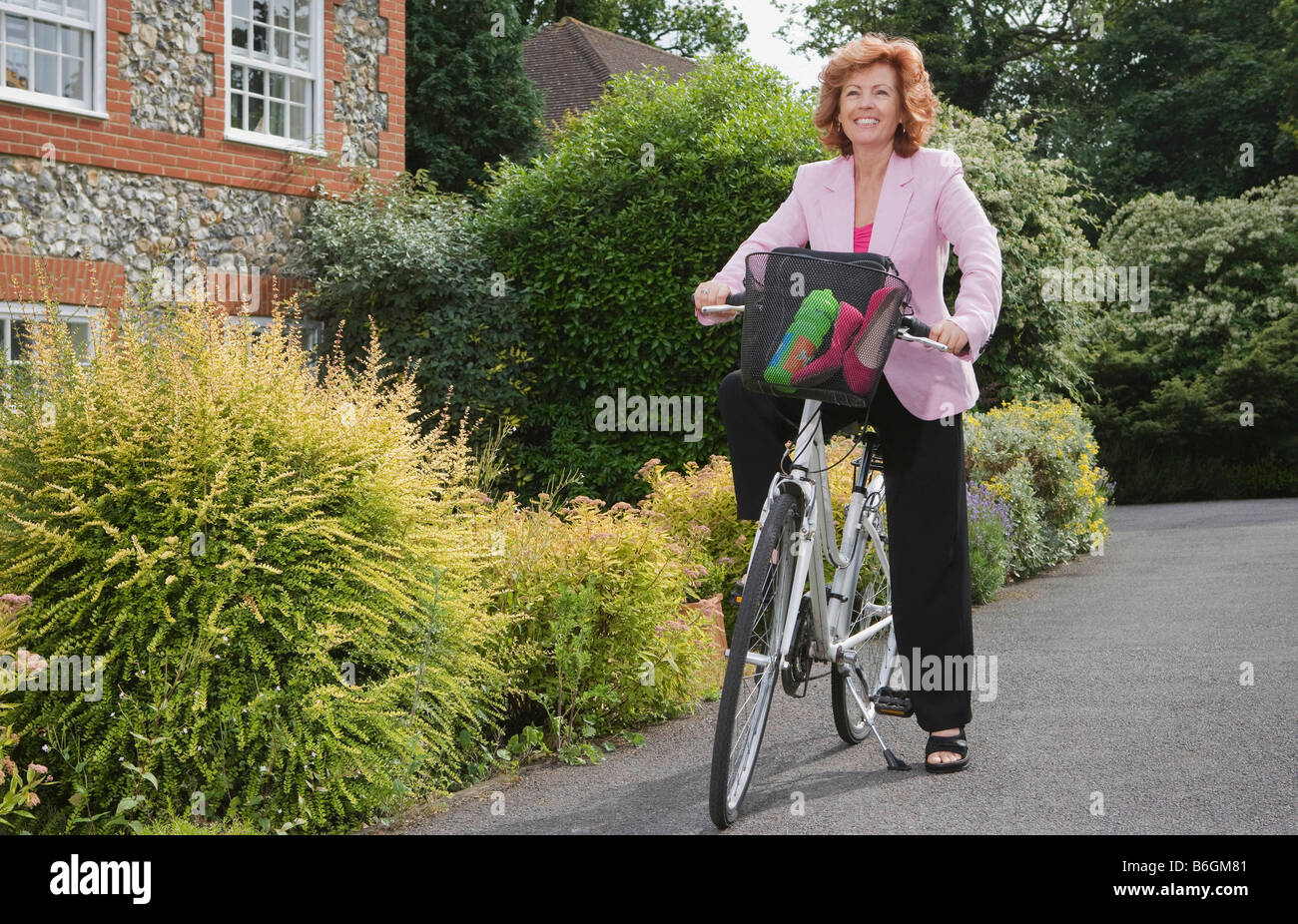 Woman on bicycle Stock Photo - Alamy
