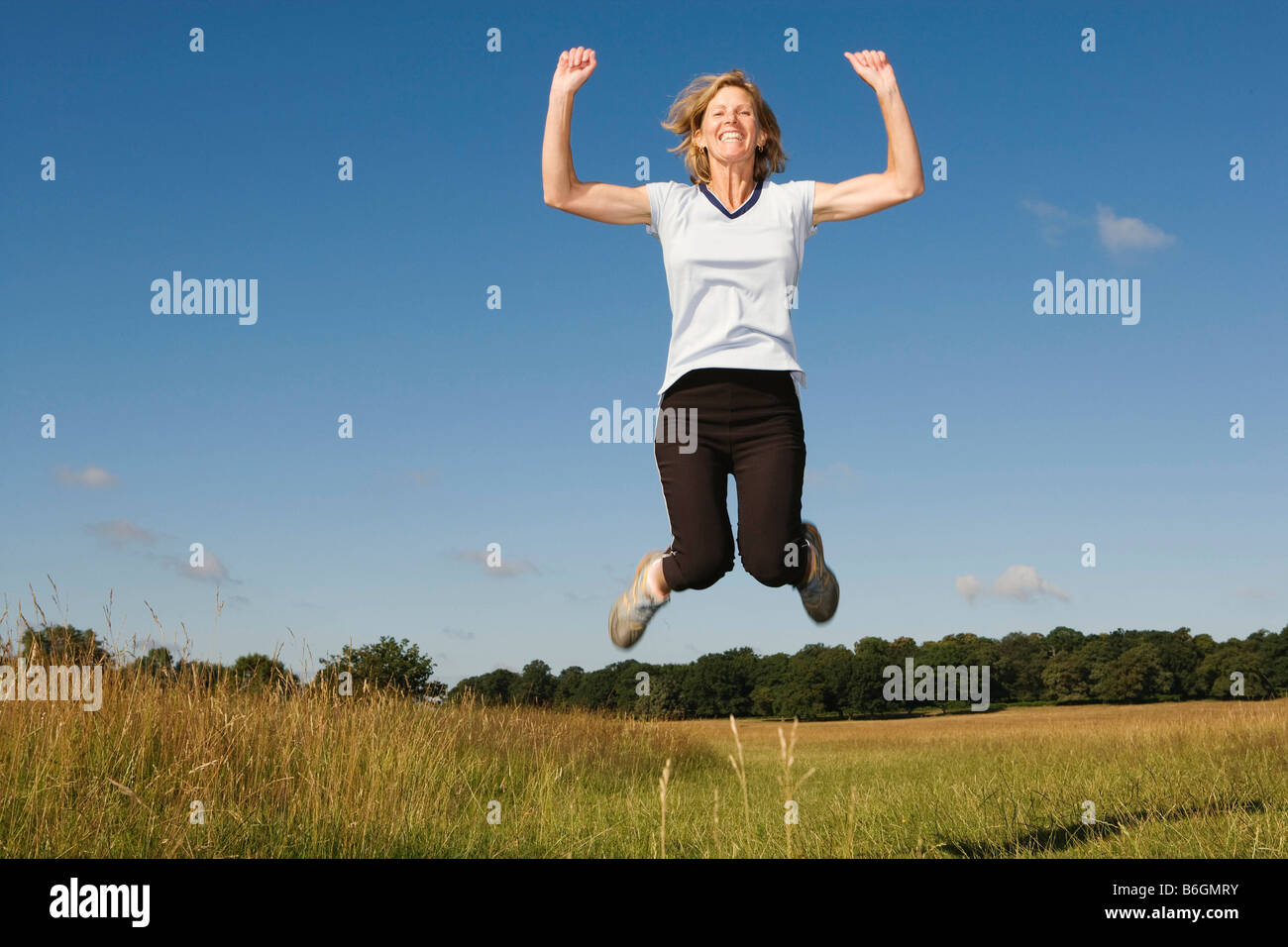 Woman runner jumping in air Stock Photo - Alamy