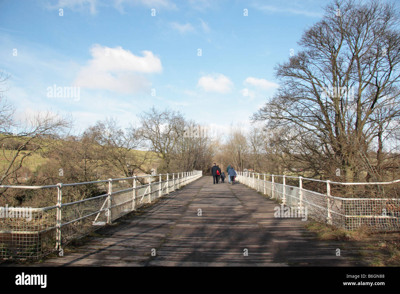 Walkers crossing the old railway bridge over the river Swale by Easby ...