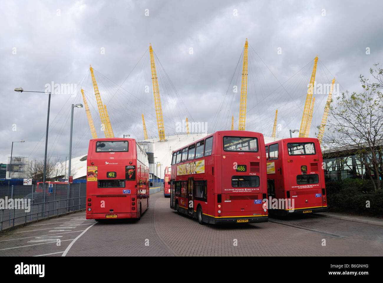 Three red London buses approaching the O2 Arena North Greenwich London ...