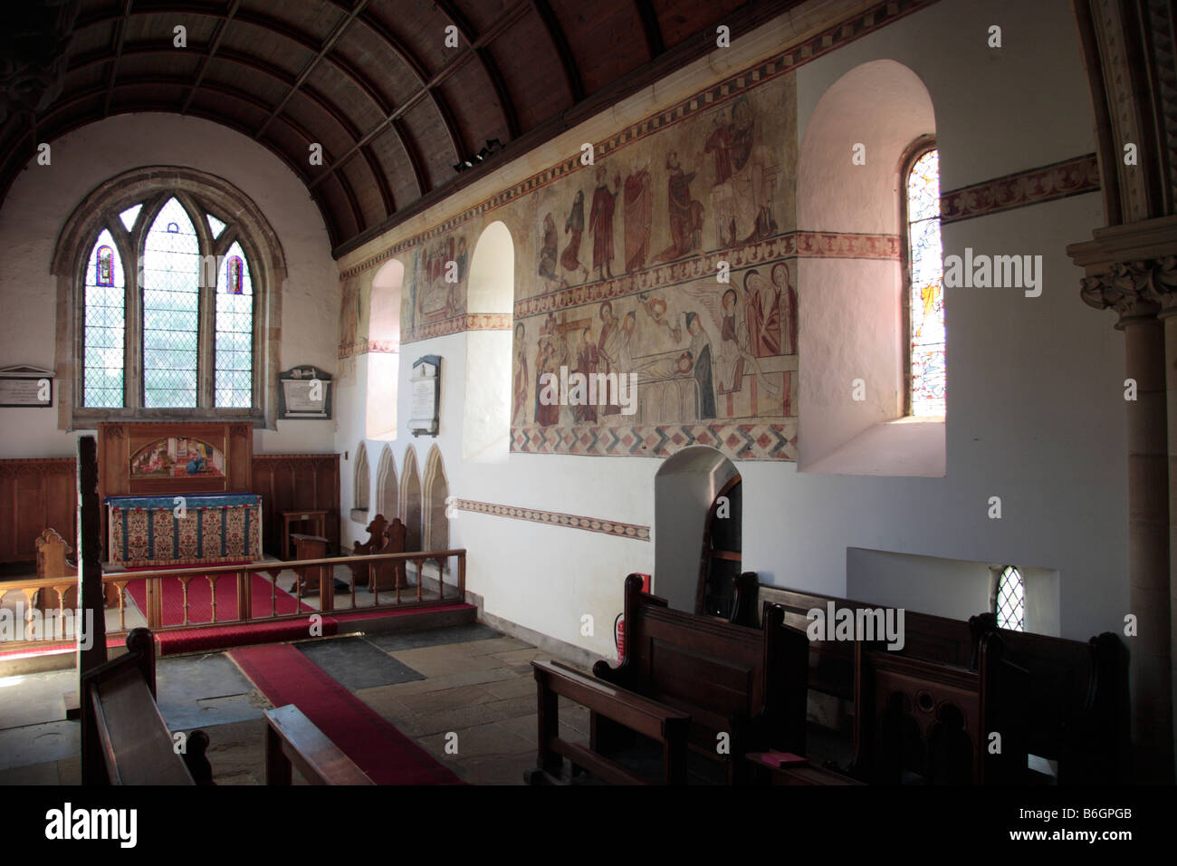 The interior of St Agatha s church showing medieval paintings of scenes ...