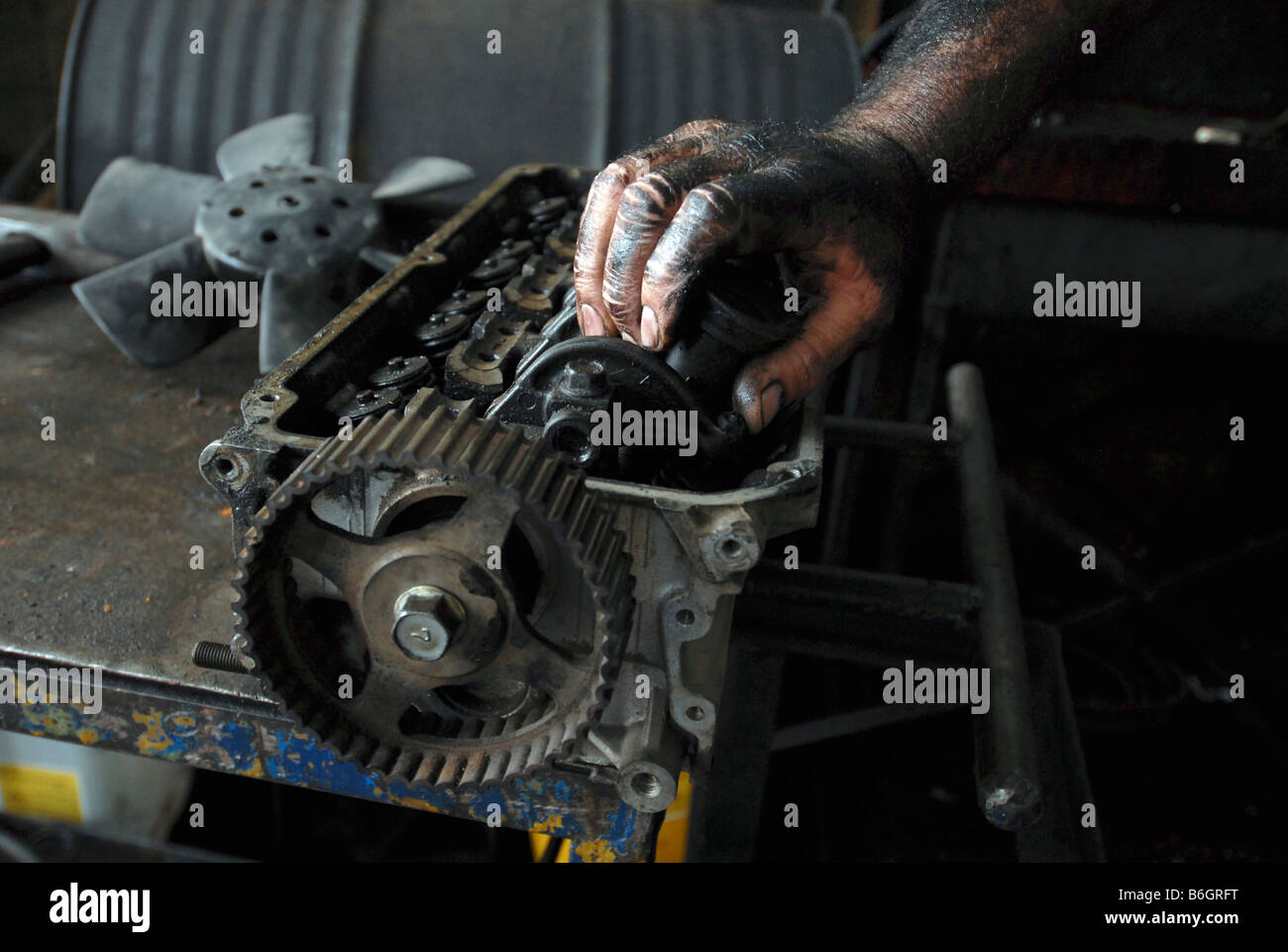 mechanic fixing a motor in a workshop Stock Photo - Alamy