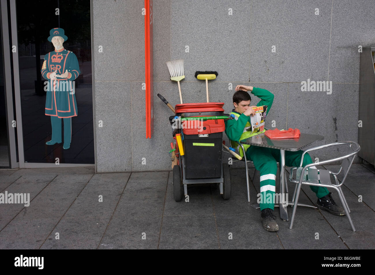 Street sweeper reads a magazine during his morning shift at the Tower ...
