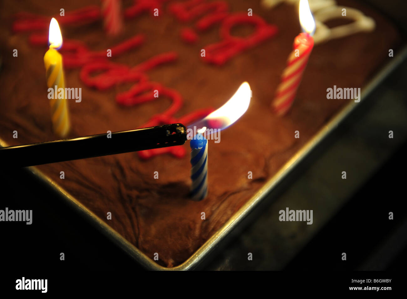 Lighter and birthday cake candle Stock Photo - Alamy