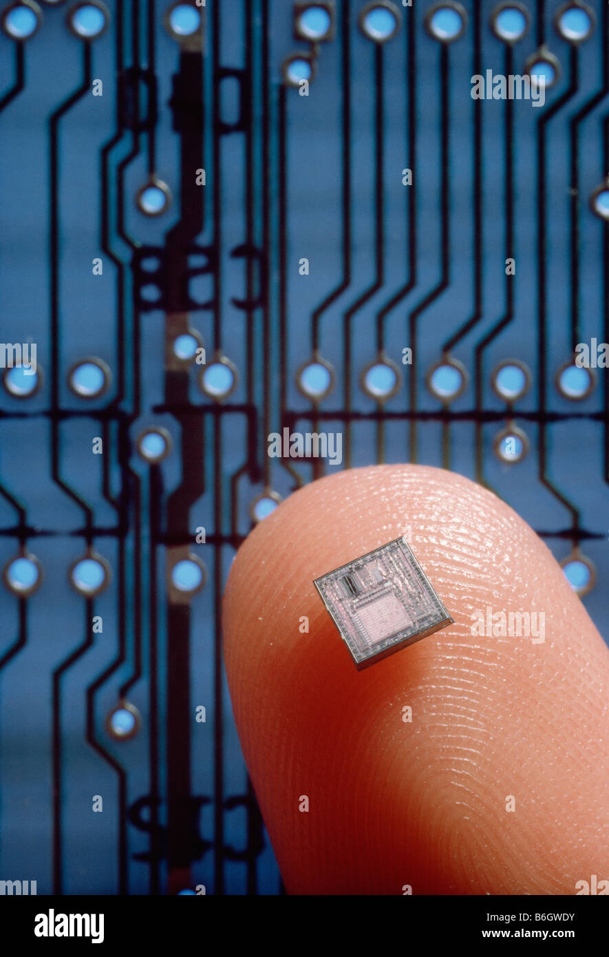 Microchip on fingertip, in front of printed circuit board 0211 006 29 ...