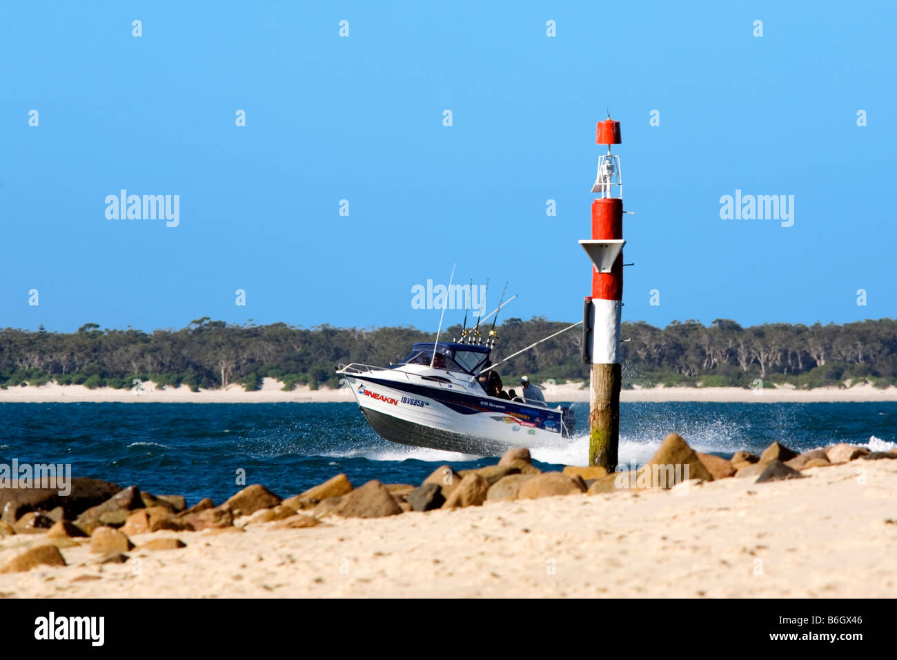 a power boat passing a channel marker Stock Photo - Alamy
