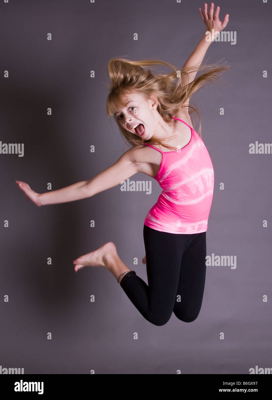Girl jumping into the air Stock Photo - Alamy