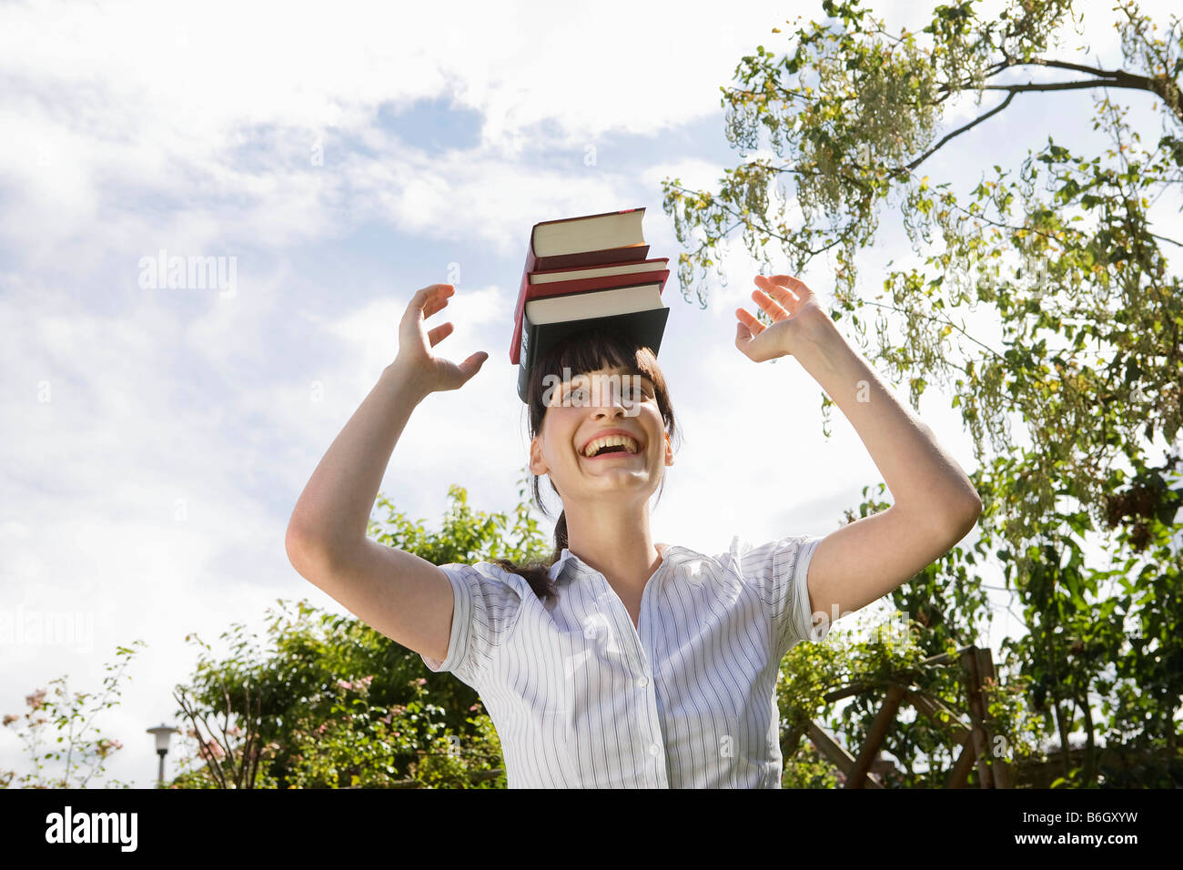 Woman balancing books head hi-res stock photography and images - Alamy