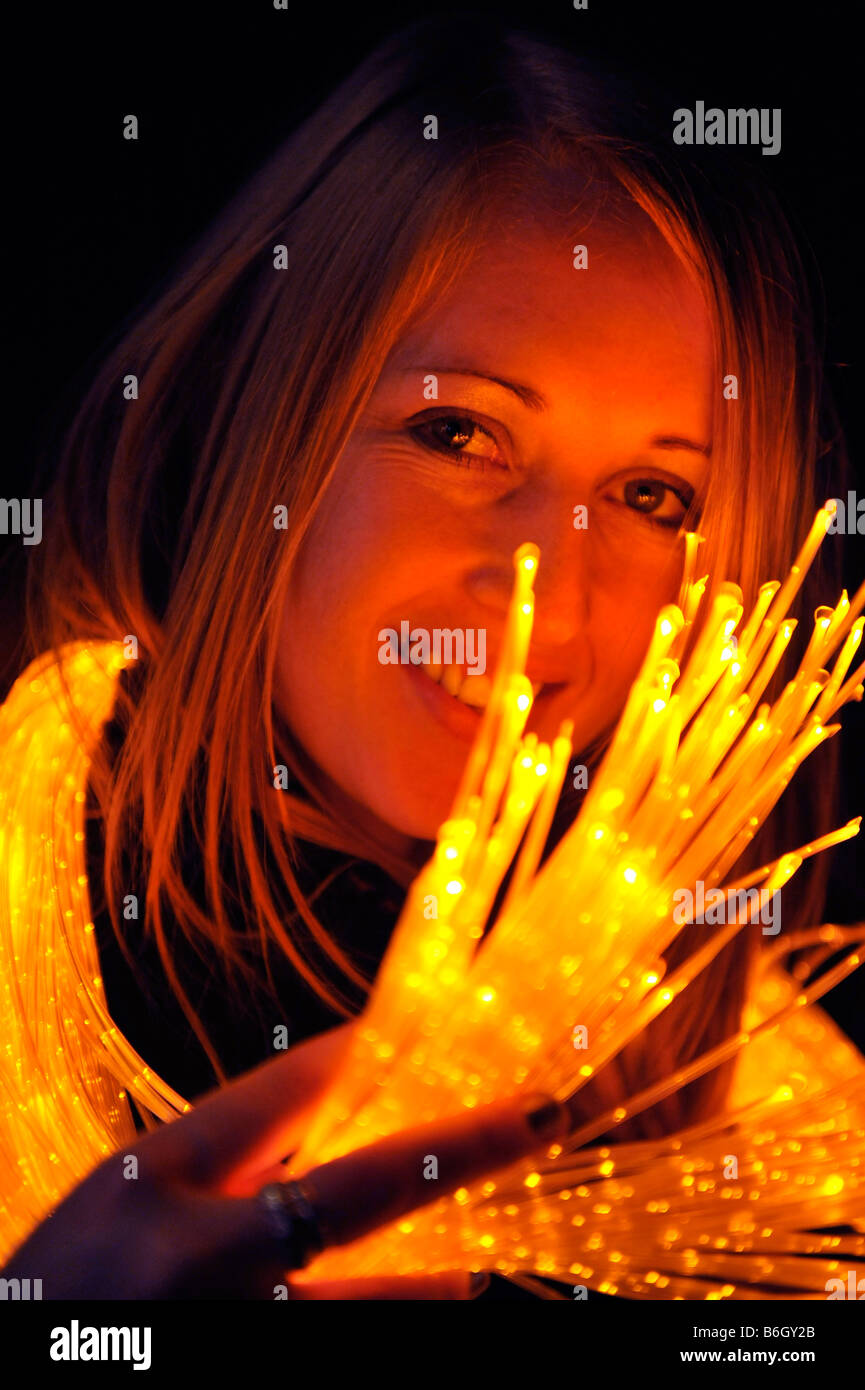 Girl wrapped fibre optic light rope portrait twenties hi-res stock ...