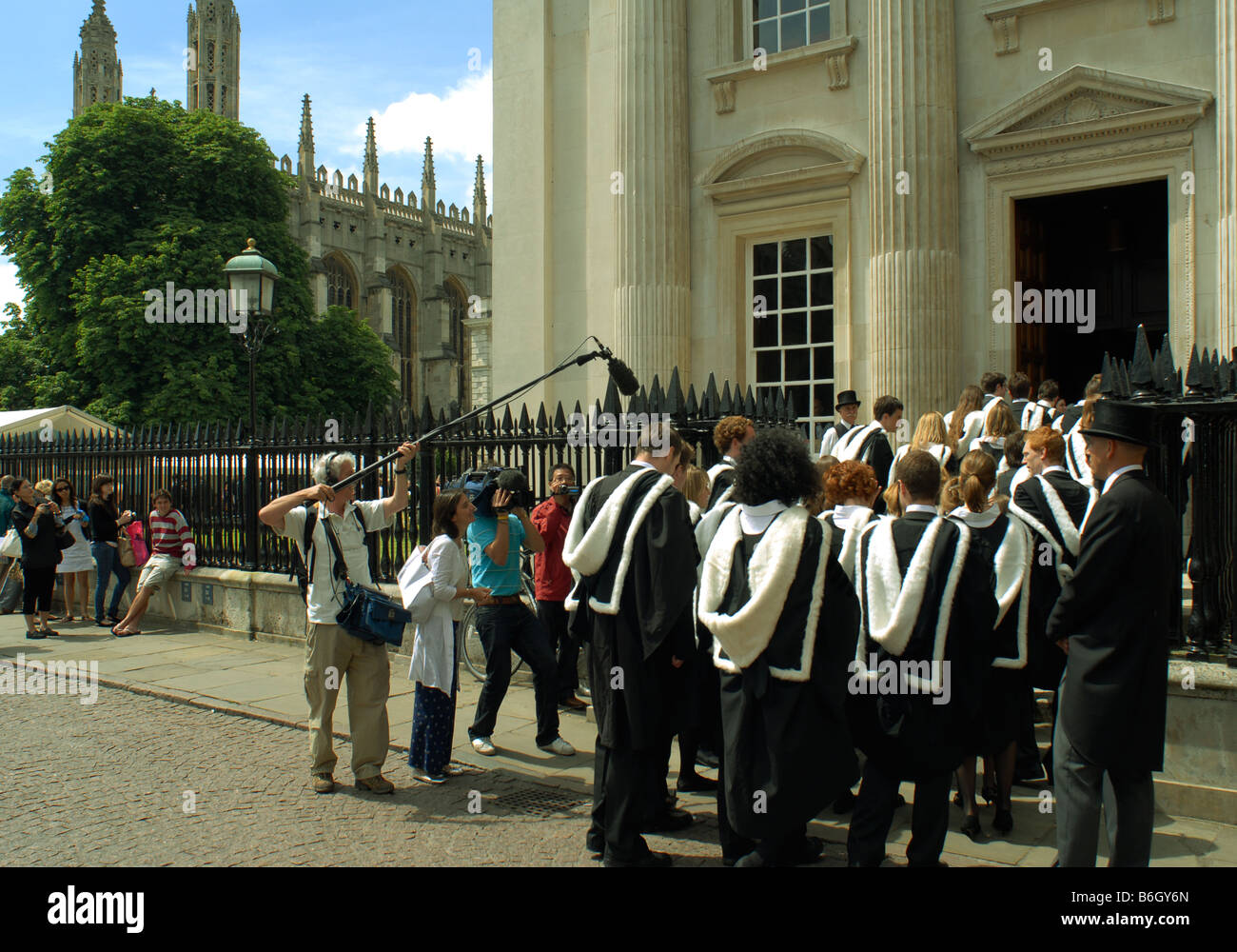 Graduands entering the Senate House in Cambridge whilst being recorded ...