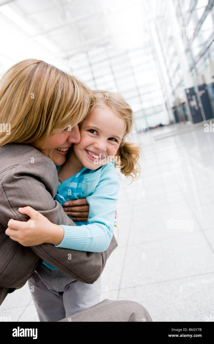 Woman embracing girl Stock Photo - Alamy