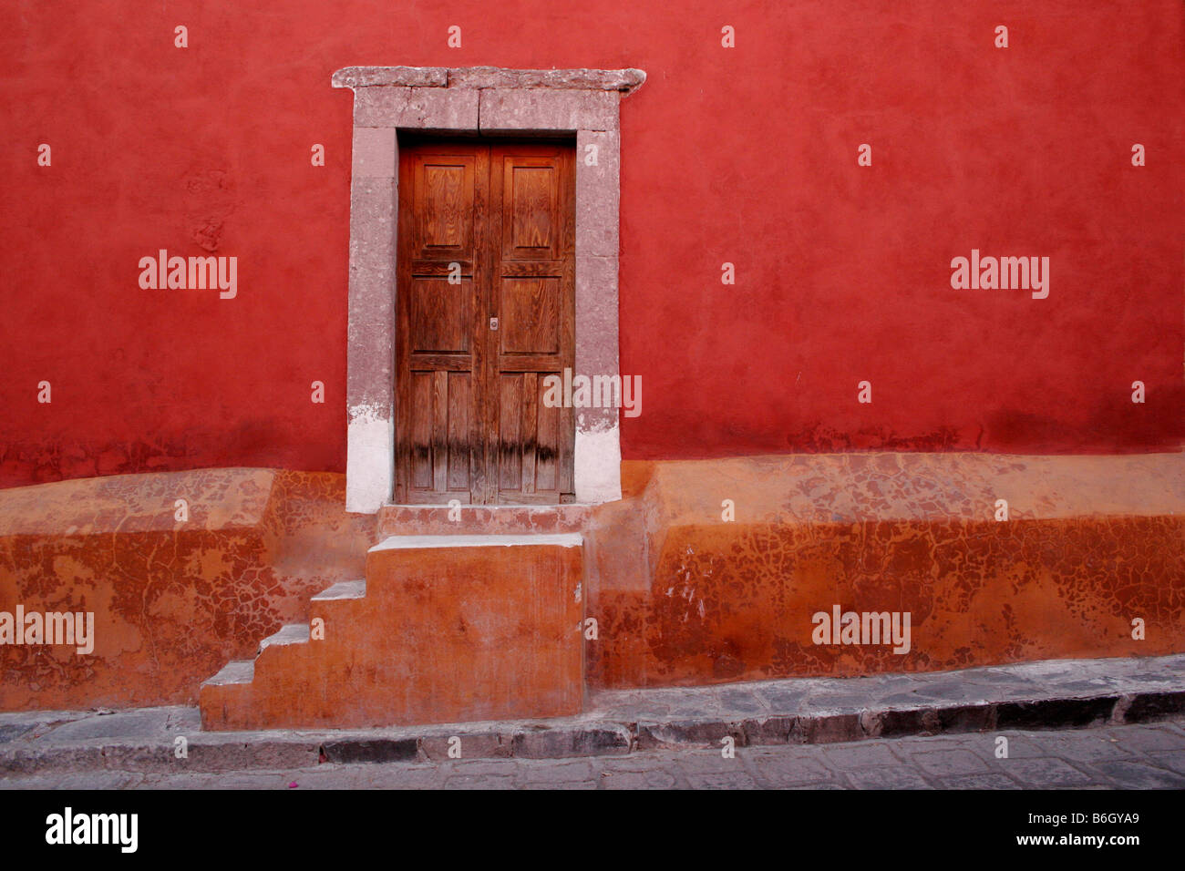 Weathered door and stone steps in colorful building in San Miguel de ...