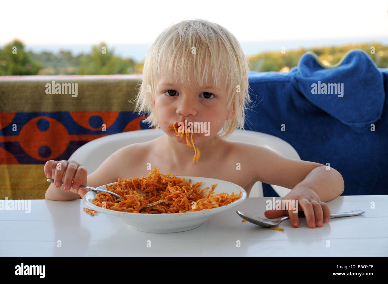 A young boy eating pasta on holiday in Italy Stock Photo - Alamy