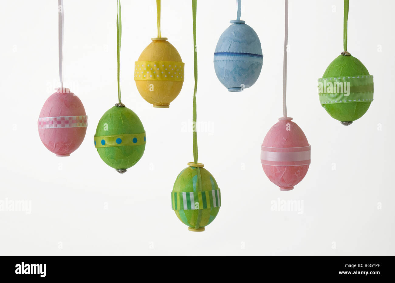 Seven colorful colourful hanging Easter eggs Stock Photo - Alamy