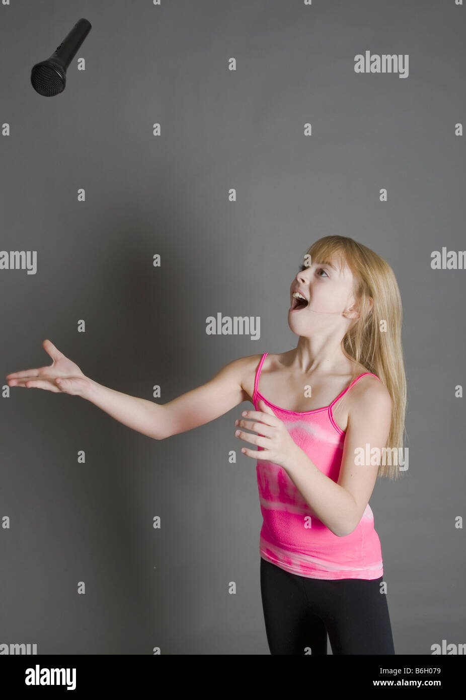Child tossing a microphone into the air Stock Photo - Alamy