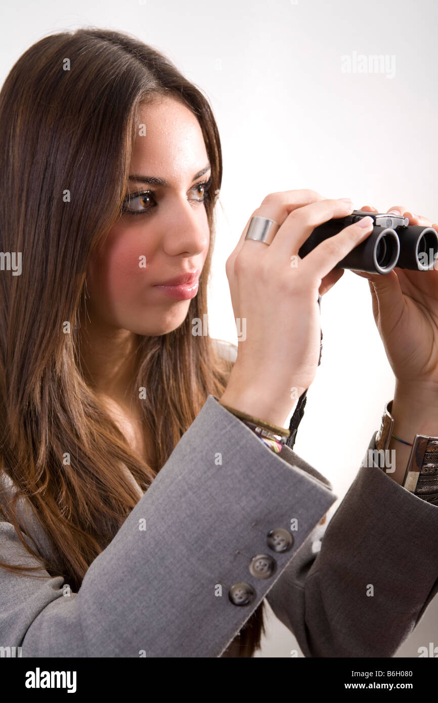 Businesswoman spying through a binocular lens Stock Photo - Alamy
