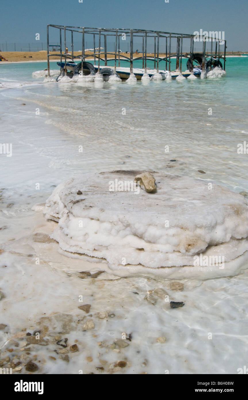 View of beach with salt-crusted stone and lifeboat, Dead Sea, Israel ...