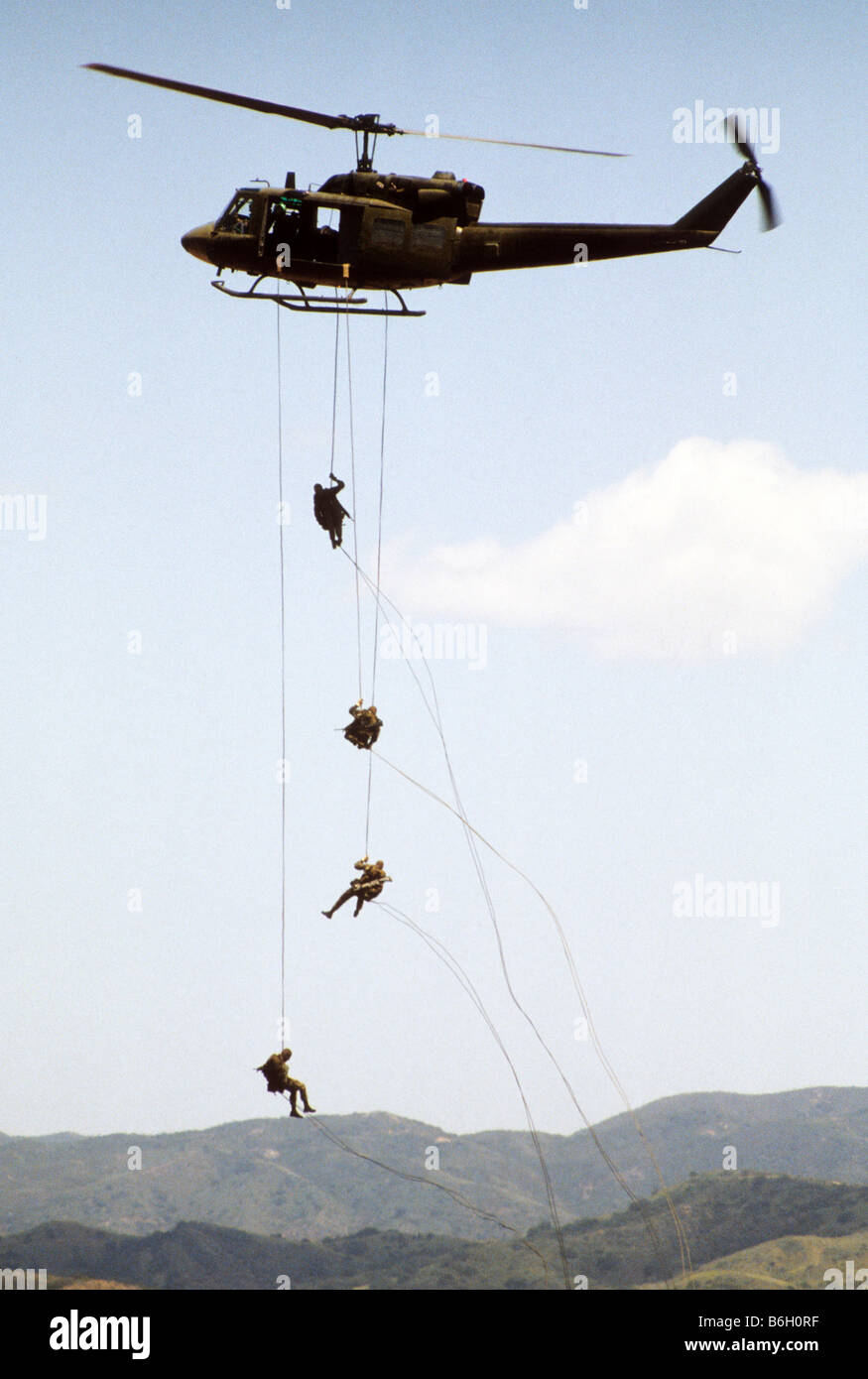 Marines slide down ropes beneath helicopter Stock Photo - Alamy
