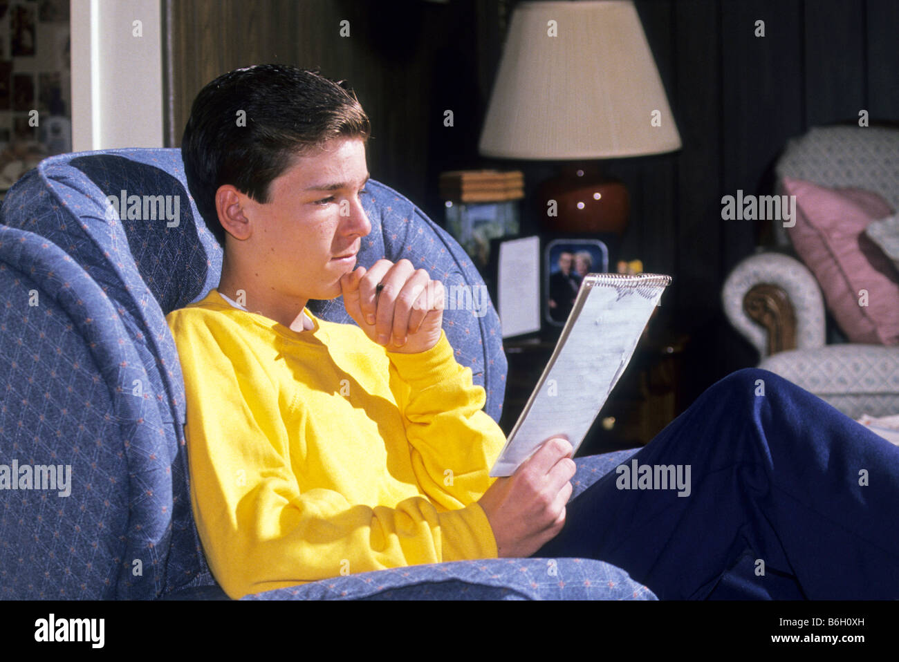 Teen boy reads at home Stock Photo - Alamy