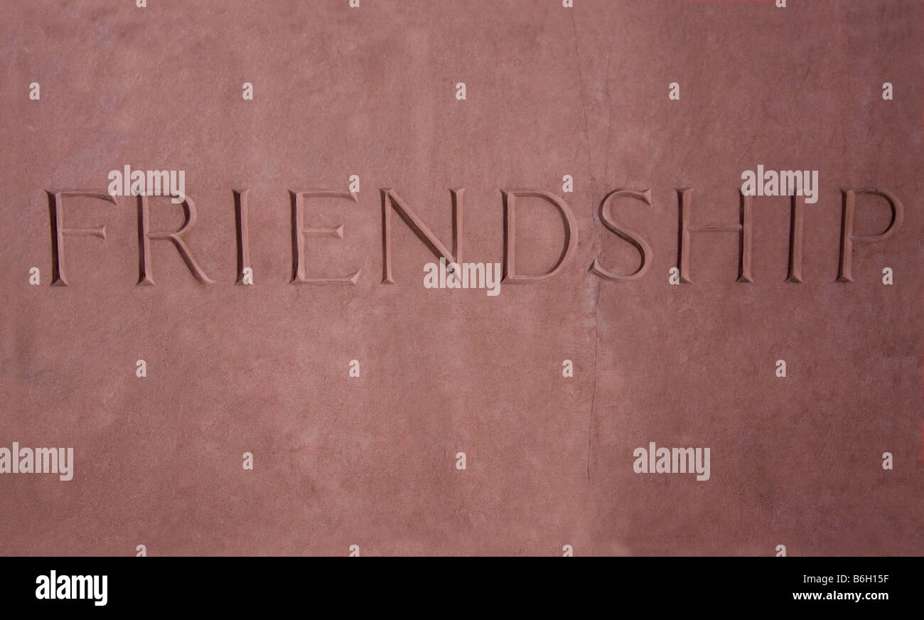 Friendship carved in stone using incised Roman lettering Stock Photo ...