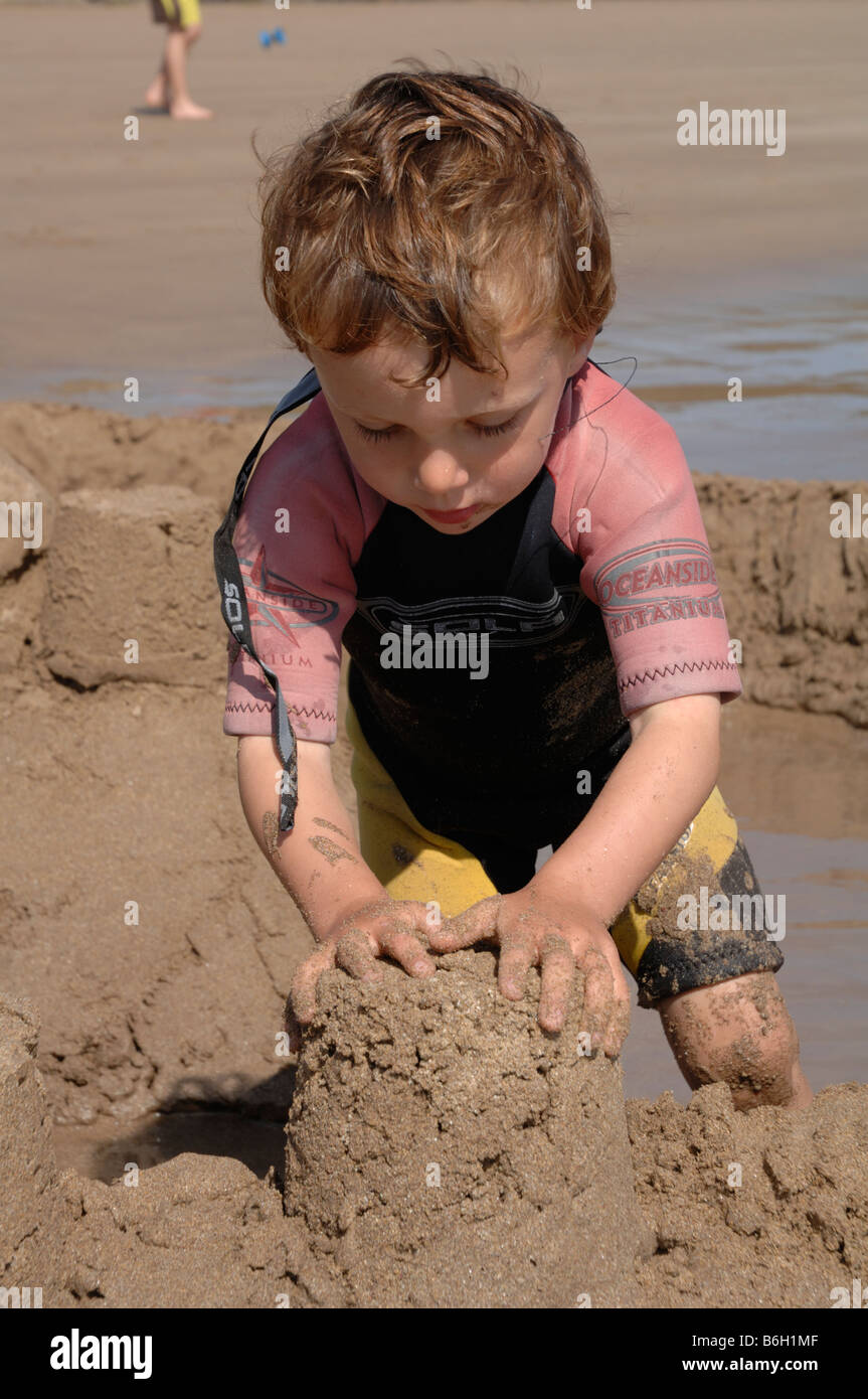 Child playing sandcastle on Marloes Sands Pembrokeshire Wales United ...