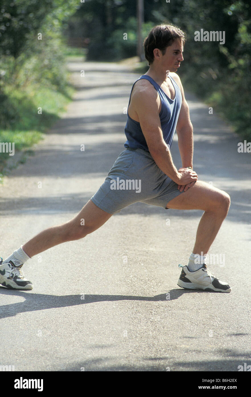 young man doing exercises out in countryside Stock Photo - Alamy