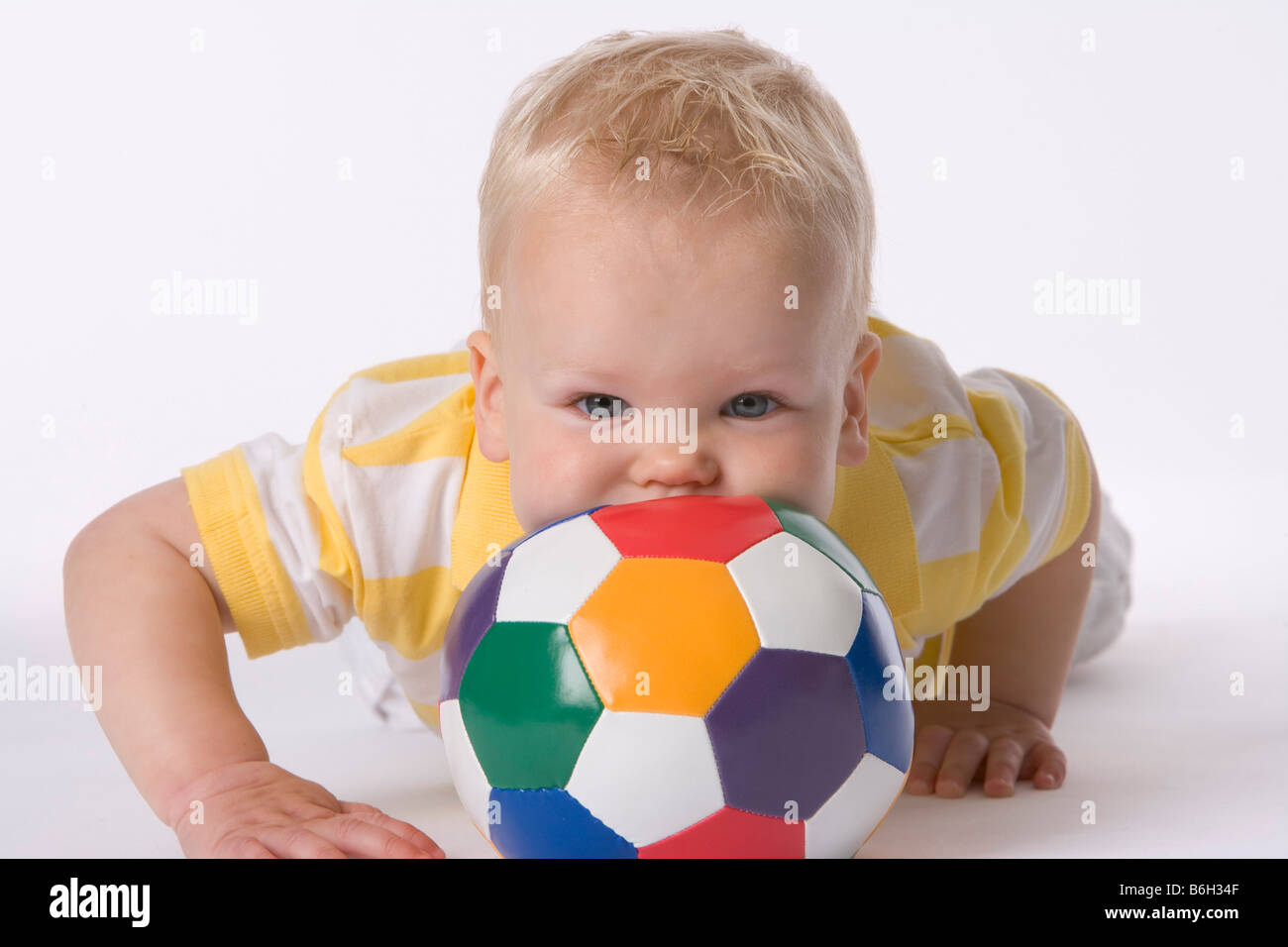Toddler playing with a ball Stock Photo - Alamy