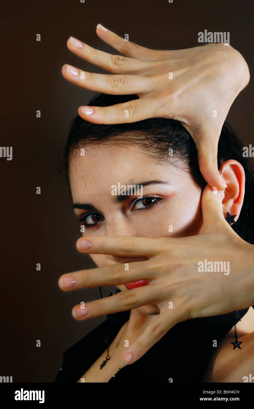 Artistic portrait of young female framing face with her hands Stock ...