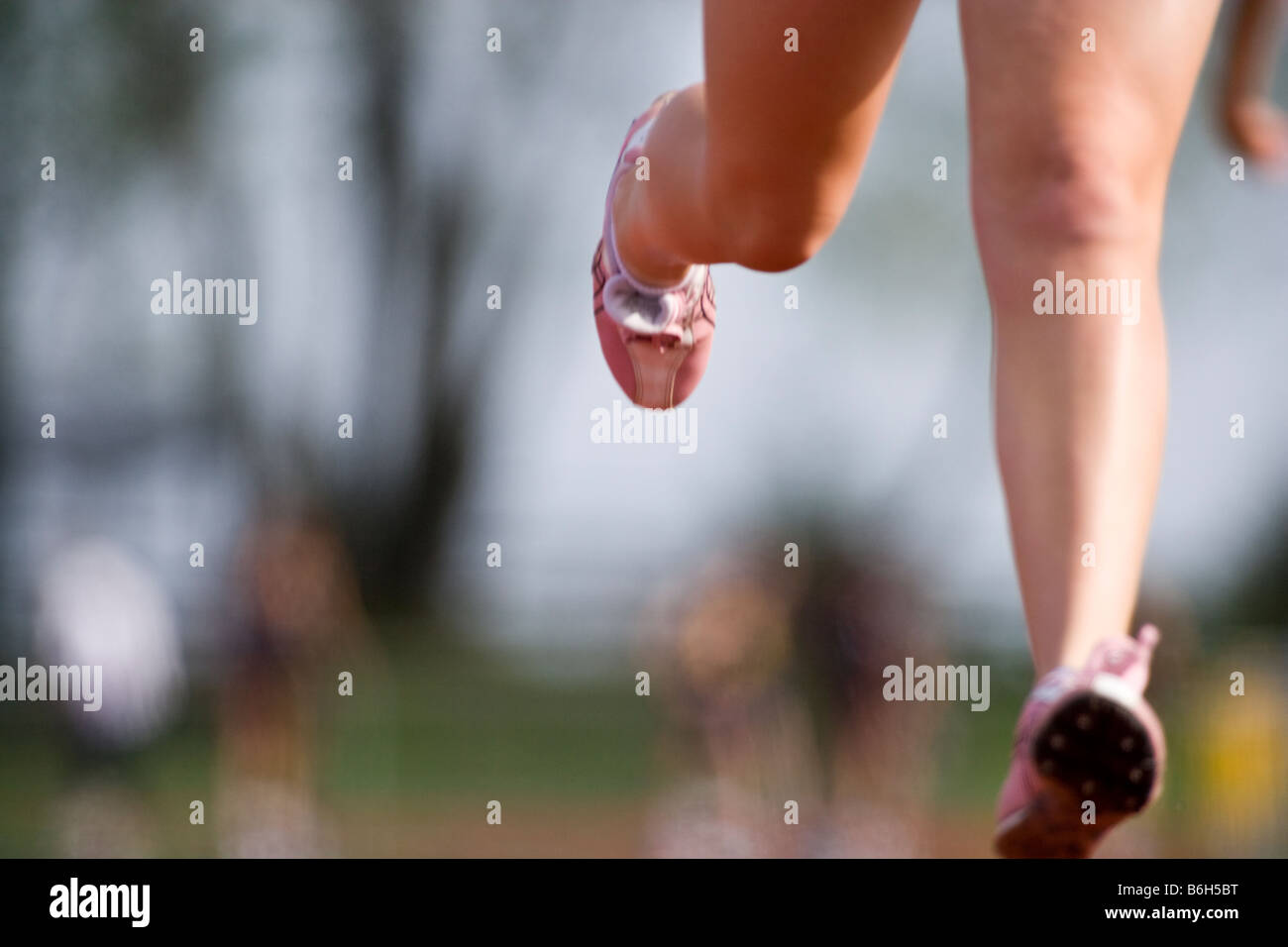 Runners on the track during a high school track & field meet Stock ...