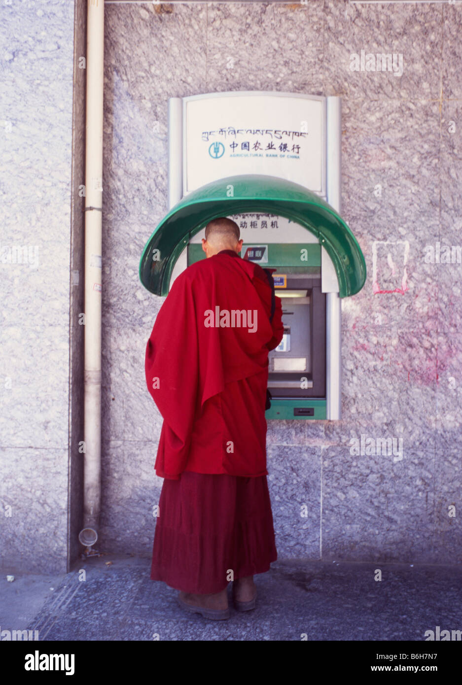 Tibetan monk at ATM machine, Lhasa Tibet Stock Photo - Alamy