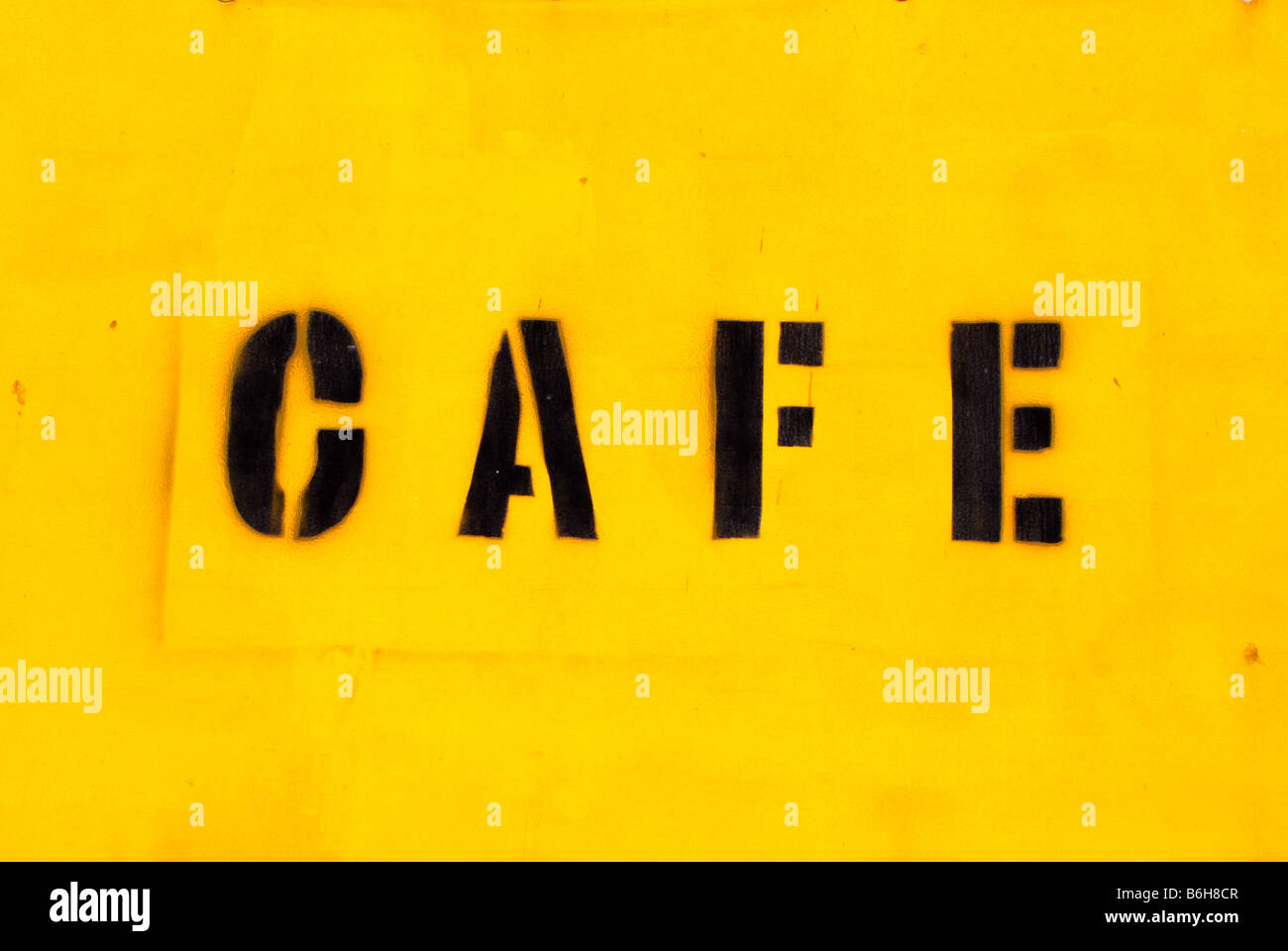 Yellow stenciled cafe sign Stock Photo - Alamy