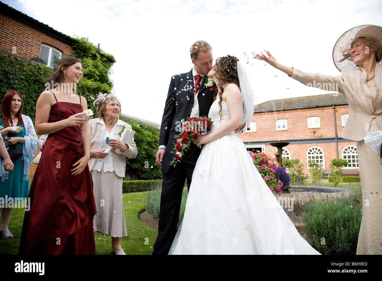 Wedding couple in confetti shower Stock Photo - Alamy