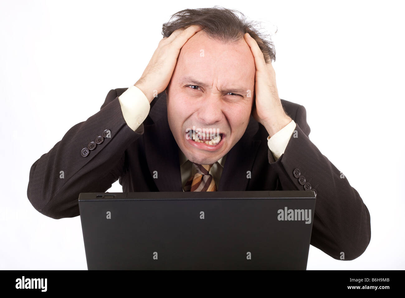desperate businessman looking at computer and crying Stock Photo - Alamy