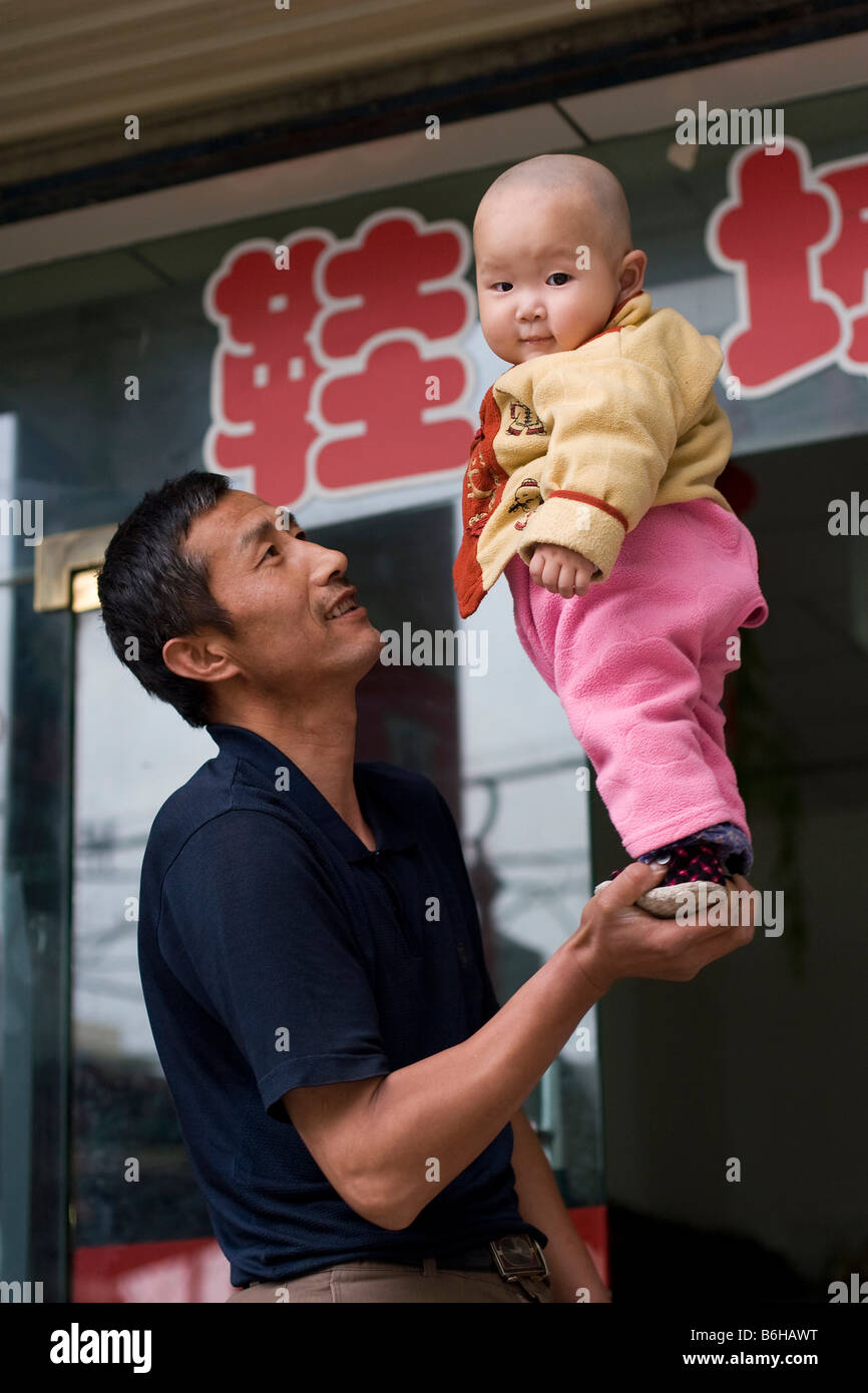 Man and child in China Stock Photo - Alamy