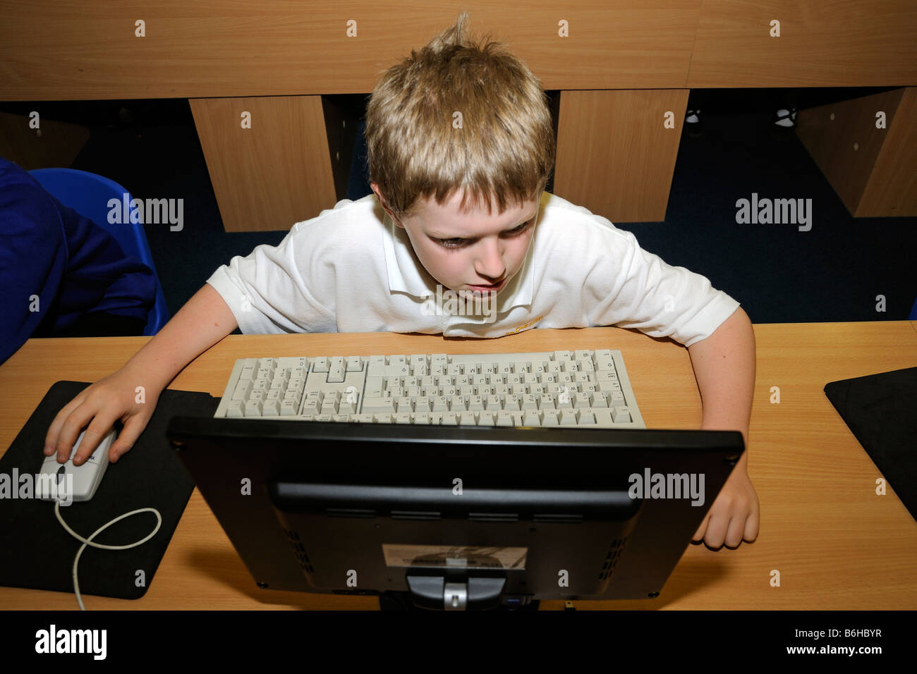 Primary school pupil using computer in classroom Stock Photo - Alamy
